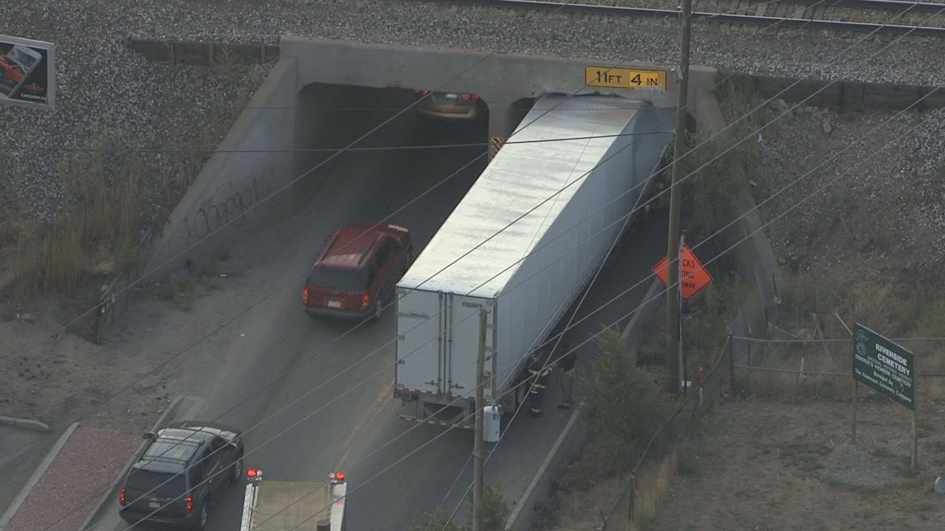 Semi-truck stuck under bridge | 9news.com