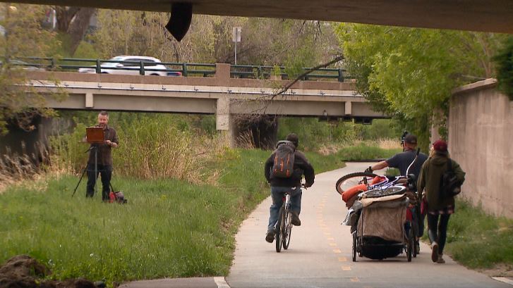 Man spotlights relocation of Denver's homeless with bridge paintings ...