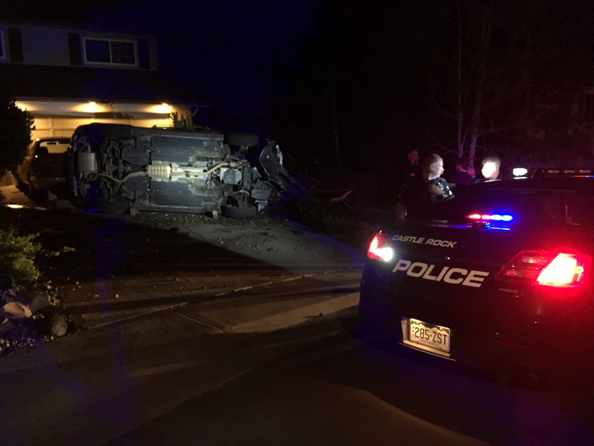 Car flips in to driveway of home | 9news.com